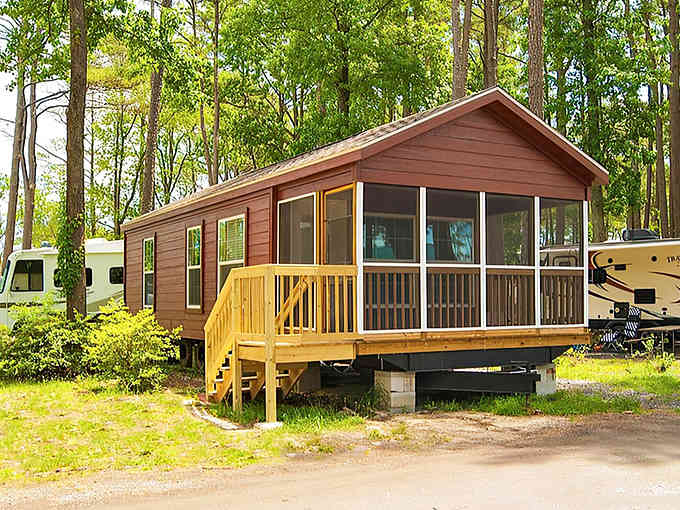 These cabins prove that "roughing it" can include screened porches and actual stairs to your front door.