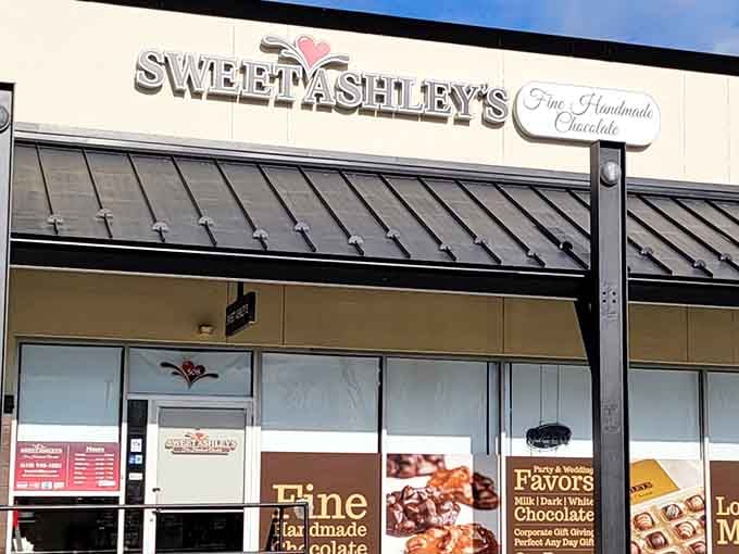 That charming pink heart logo above the entrance promises exactly what's inside: handmade chocolate worth every calorie.