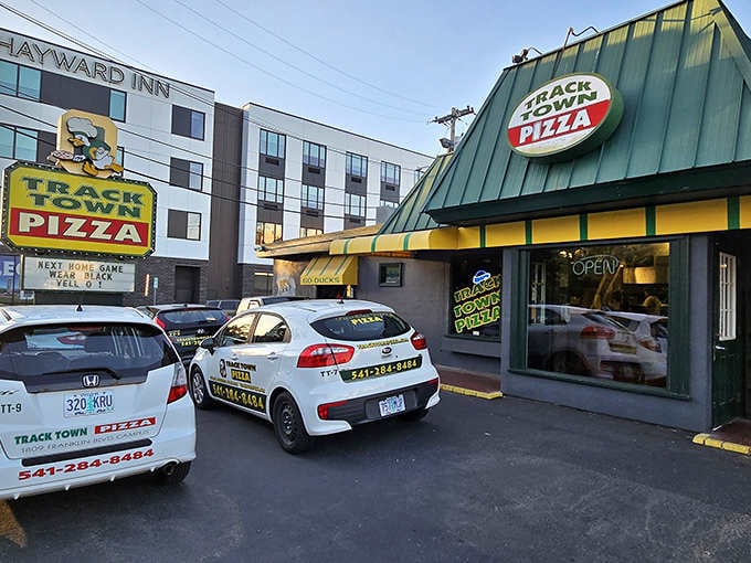 Evening glow transforms this local favorite into a beacon for hungry souls seeking authentic pizza perfection.