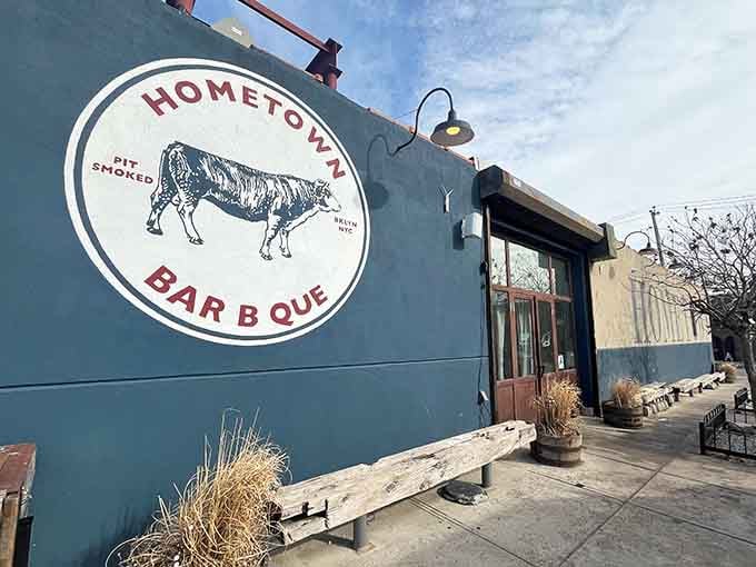 That blue exterior with the pit-smoked cow logo isn't just signage, it's a promise written in smoke and dreams.
