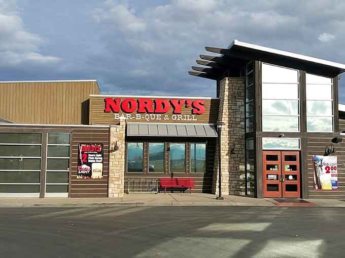 Modern architecture meets old-school barbecue tradition, where stone and steel frame the promise of perfectly smoked ribs inside.