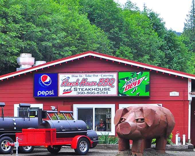 The red barn exterior and serious smoker setup prove this place means business about barbecue, no games here.