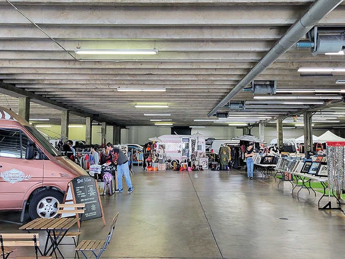 Under industrial ceilings, vendors display their wares next to a pink classic car that's probably worth more than your house.