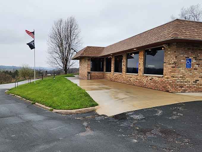 That classic brick exterior and rolling hill backdrop practically whisper "supper club" before you even step inside.