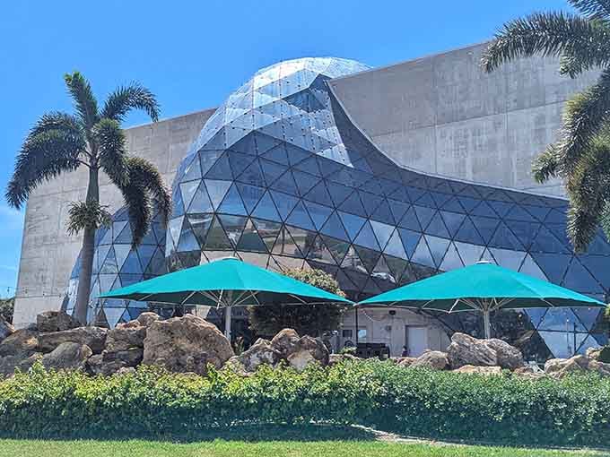 That glass bubble bursting through concrete isn't an architectural accident, it's pure intentional genius welcoming you inside.