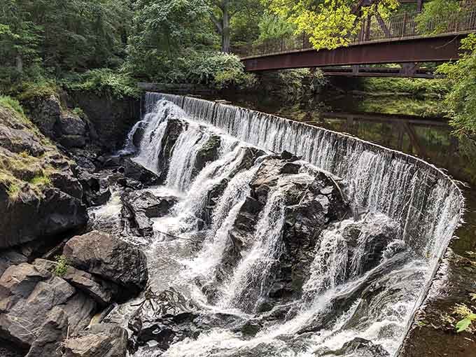 Water cascading over ancient rocks like nature's own staircase, proving Connecticut does drama beautifully.