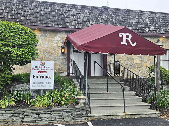 That red awning and stone facade promise one thing: you're about to eat very, very well.