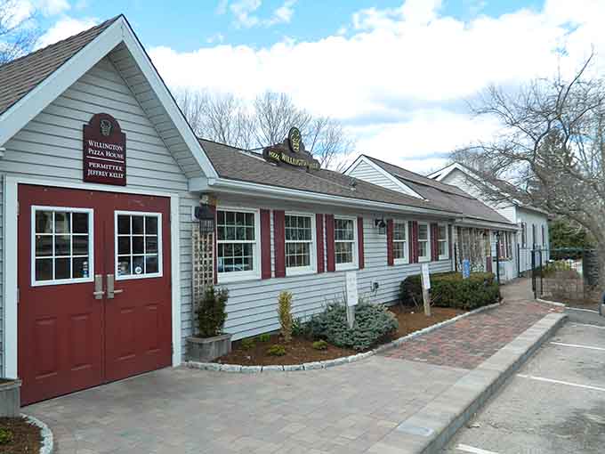 This charming New England exterior hides one of Connecticut's best-kept pizza secrets inside those welcoming red doors.