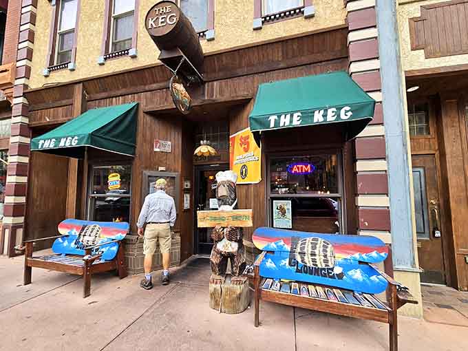 That wooden bear and those colorful benches are basically Manitou Springs saying hello before you even walk inside.
