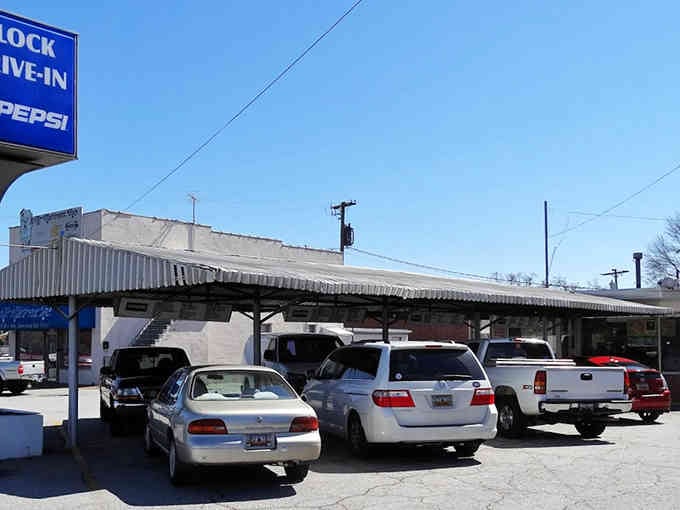 Classic cars gather under the canopy, proving some traditions never go out of style or flavor.