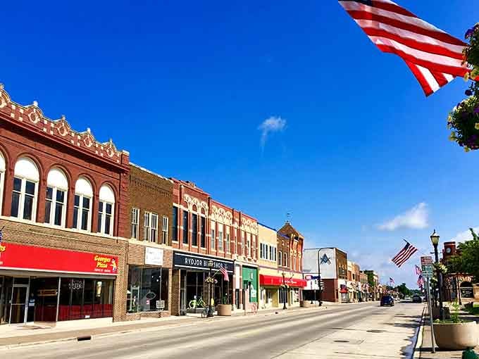Stars and Stripes flying high over brick buildings that have weathered more than a century of summers.