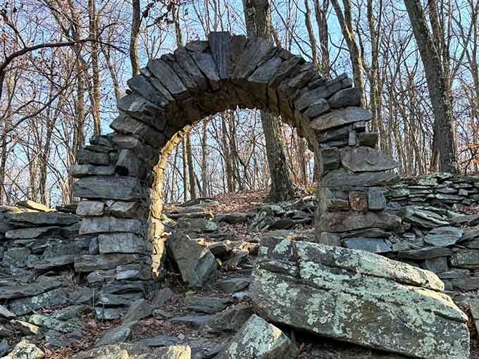 Stone archways standing sentinel in the forest, silent witnesses to centuries of history passing beneath their weathered frames.
