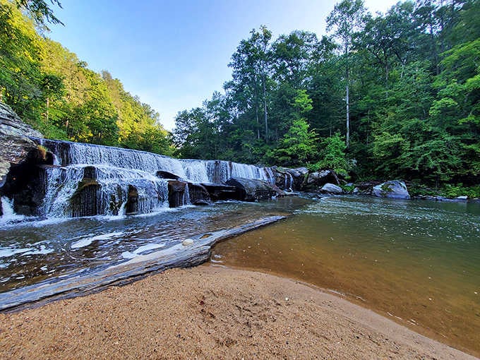 That layered waterfall spilling into an amber pool is basically nature's version of a luxury resort infinity pool.