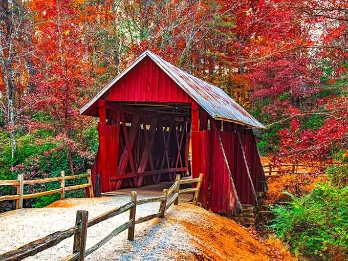 This covered bridge surrounded by fall colors looks like autumn decided to show off its entire paint collection.