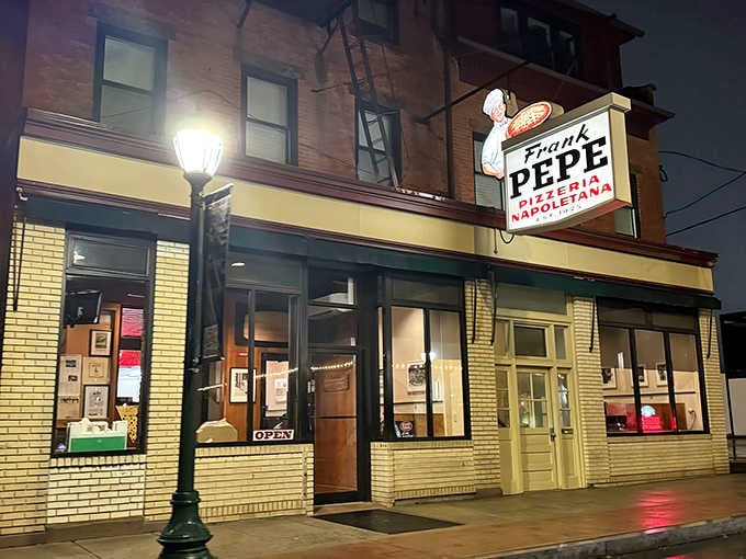 That iconic sign has been beckoning pizza lovers like a delicious siren song for nearly a century now.