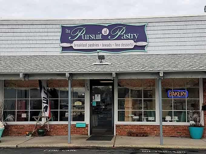 That purple signage promises breakfast pastries, breads, and fine desserts, delivering on every delicious word.