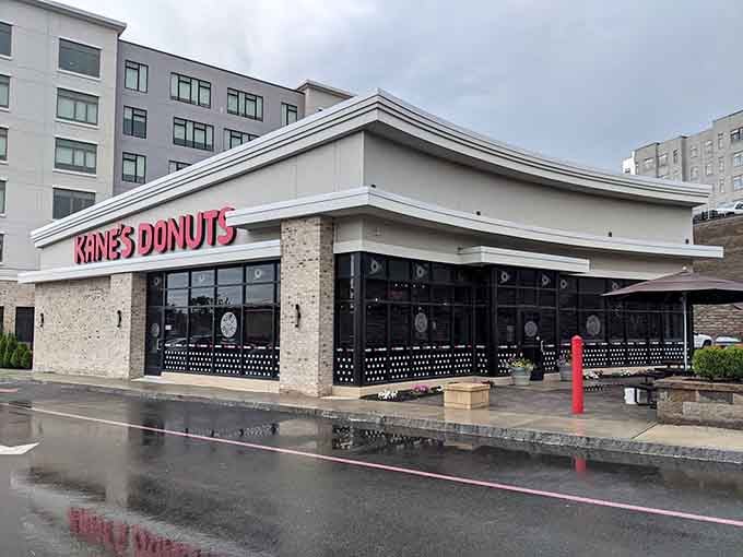 The modern facade promises fresh donuts inside, and spoiler alert: it absolutely delivers on that promise.