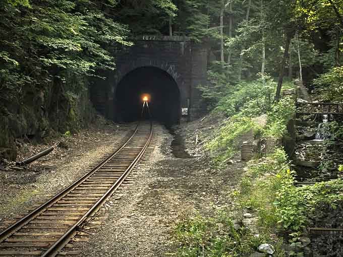 The drainage channel alongside the tracks hints at the flooding problems that plagued workers throughout this nightmarish project.