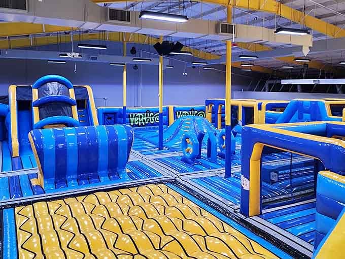 Yellow and blue obstacles stretch endlessly, creating an inflatable wonderland that makes adulting seem wildly overrated.