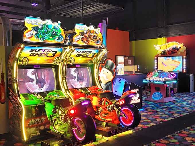 Chrome handlebars gleaming under arcade lights, because who needs a real motorcycle license when you've got quarters?