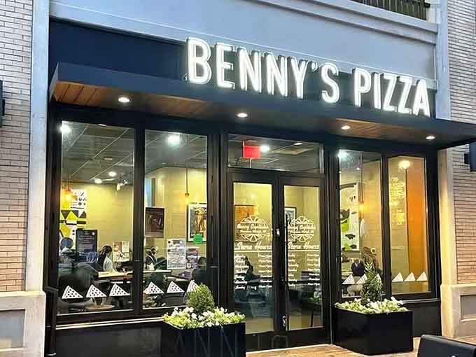 That storefront glow means serious pizza business is happening inside, and your stomach already knows it.