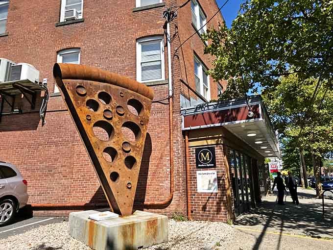 That giant pizza slice sculpture outside isn't just art, it's a promise of what awaits inside.