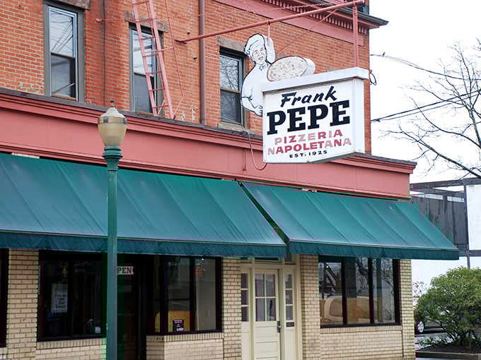 That classic sign and green awning have been beckoning pizza lovers like a siren song since the Roaring Twenties.