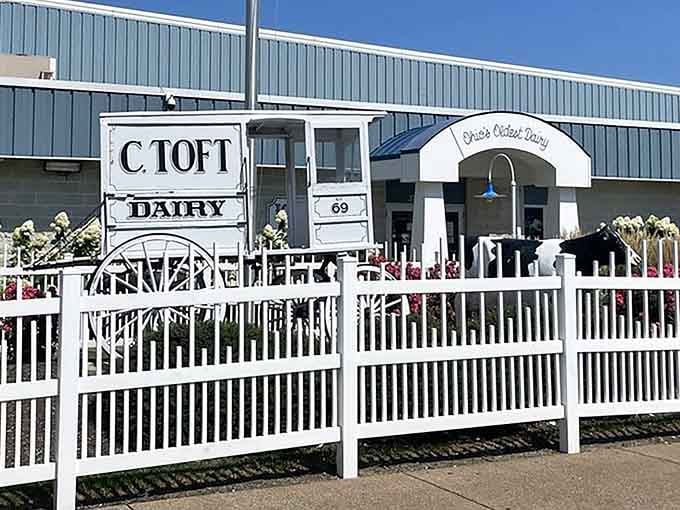 White picket fencing and manicured grounds frame the entrance, creating an inviting atmosphere that screams summer nostalgia perfectly.