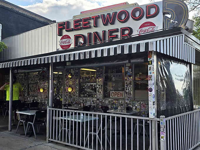 Step into this iconic, neon-lit roadside gem featuring a nostalgic exterior covered in fun stickers and a welcoming outdoor patio.