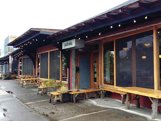 That welcoming exterior with picnic tables practically begs you to sit down and get messy with ribs.