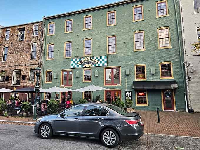 That green facade with red trim isn't just pretty, it's basically a beacon calling you to pizza paradise.