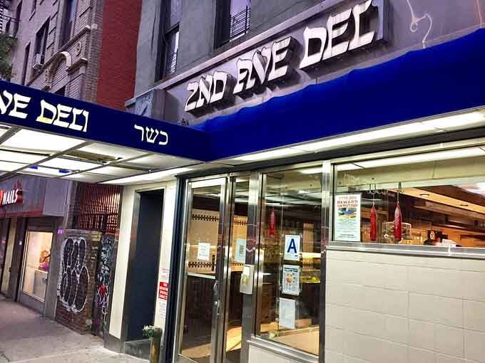 That blue awning is your beacon to sandwich nirvana, where Hebrew letters spell out delicious destiny.