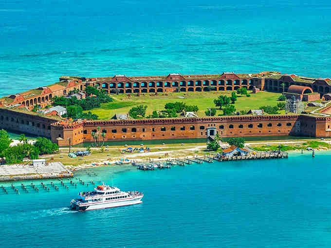This fortress rising from turquoise waters looks like someone's ambitious Minecraft project come to life.