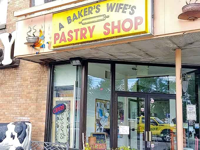 That cheerful yellow sign and friendly cow statue promise exactly what's waiting inside: pure, unapologetic pastry happiness.