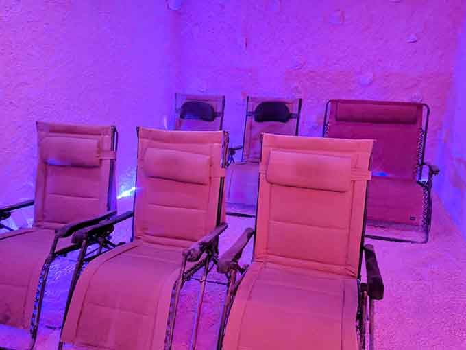 Purple and pink lighting transforms this salt therapy room into something straight out of a sci-fi spa dream.