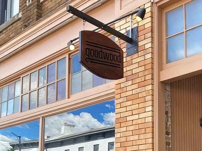 That wooden sign hanging above the cream-colored brick isn't just marking a location, it's pointing you toward burger enlightenment in downtown Frankfort.