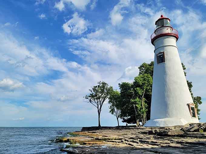 The red-topped tower gleams against blue skies, proving Ohio's got serious coastal charm hiding in plain sight.