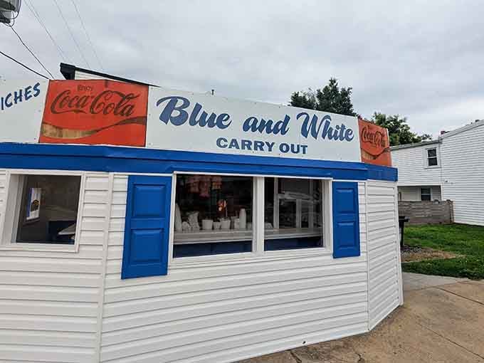Those vintage Coca-Cola signs aren't trendy décor choices; they're original fixtures that have witnessed decades of perfectly fried chicken leaving through that window.