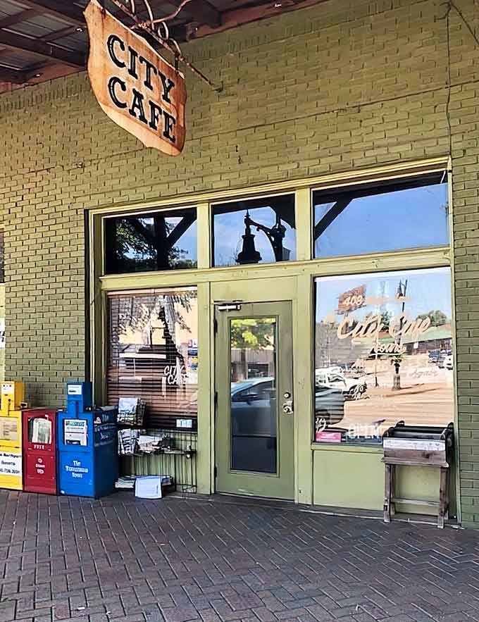 That weathered sign hanging above green-trimmed windows promises something special, and boy, does it deliver on that promise.