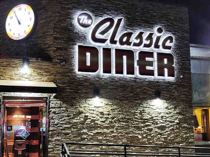 That stone facade and neon glow prove diners can have architectural swagger while still serving eggs over easy.