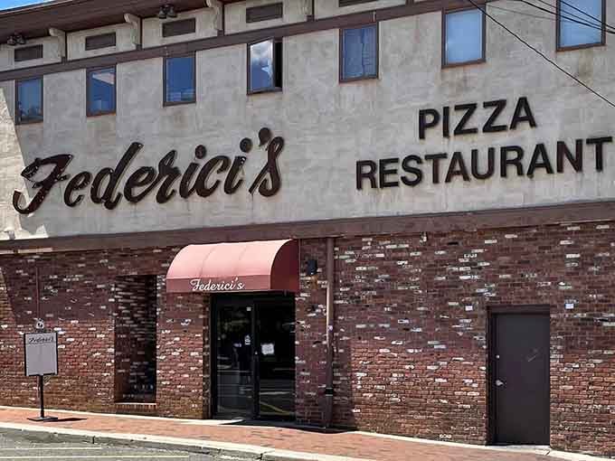 The red awning beckons like a lighthouse for carb-lovers, guiding you safely to pizza paradise and beyond.