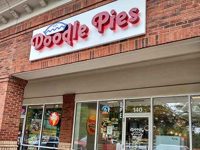 That cheerful red signage against brick is basically waving you down from the street like an old friend.