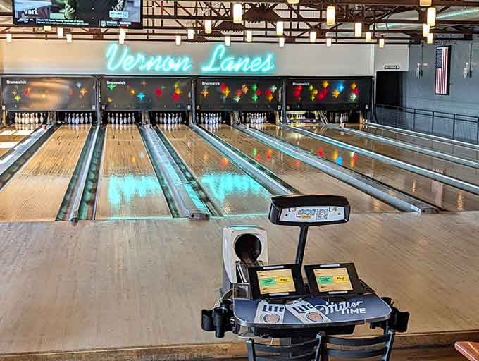 Those gleaming lanes stretch toward infinity like a highway to happiness, complete with vintage neon dreams overhead.