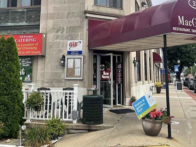 The white picket fence and flower pots create a welcoming entrance that says "come hungry, leave happy."
