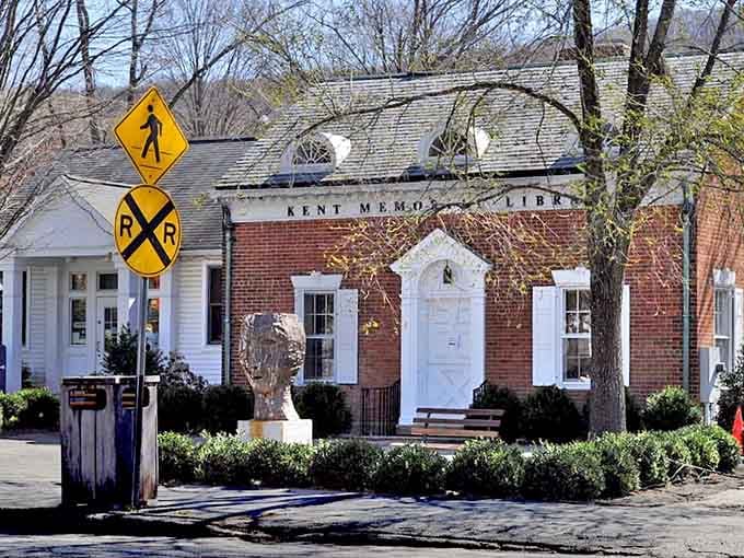 Kent's Memorial Library sits right where the railroad tracks cross, proving small towns can multitask beautifully with books and trains.