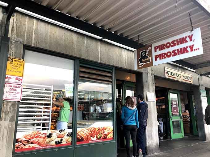 That window display of golden pastries is doing more heavy lifting than a gym membership, drawing crowds like moths to delicious flame.