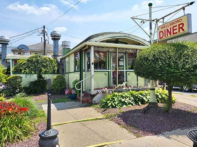 The vintage entrance welcomes you with flowering plants and that unmistakable promise of comfort food ahead.