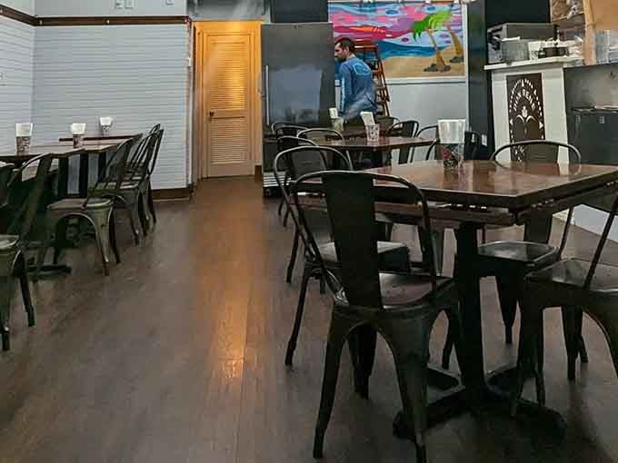 Industrial-chic meets neighborhood warmth with metal chairs, bright artwork, and that unmistakable taqueria energy in the air.