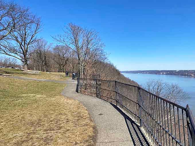 The paved walkway curves along the clifftop like nature's own red carpet, inviting you to the show of a lifetime.