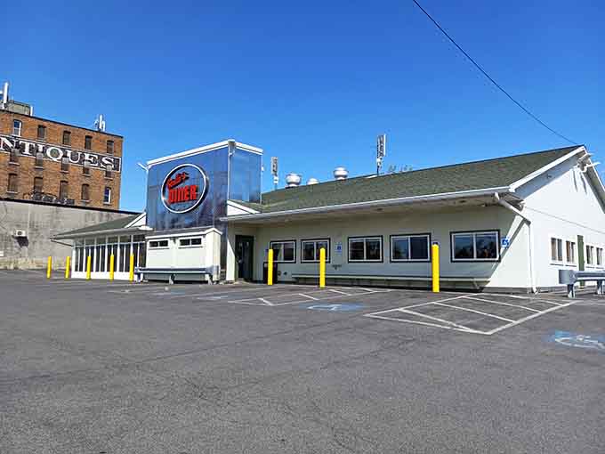 That gleaming retro sign and classic diner architecture practically demand you pull over for breakfast immediately.
